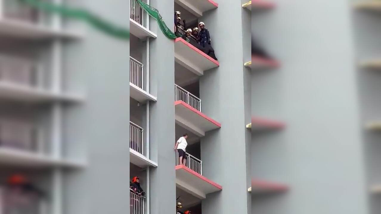 Woman Standing On Building Ledge Gets A Surprise Rescue From Emergency ...