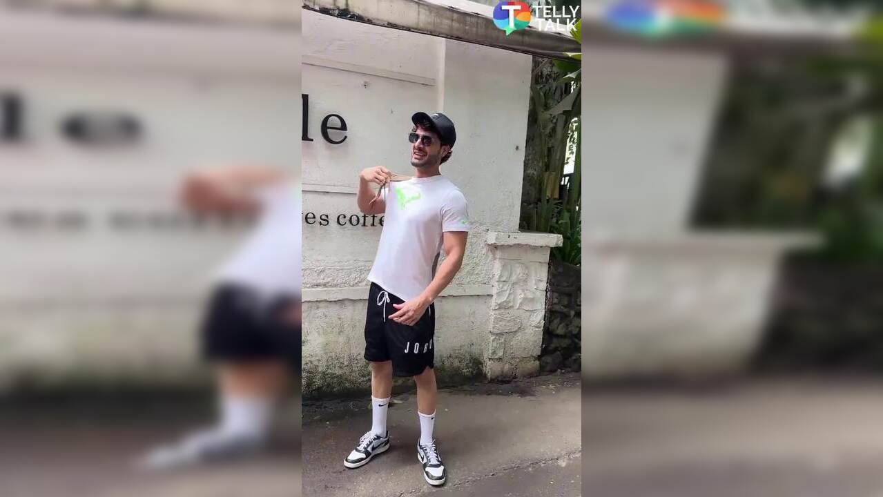 Umar Riaz waits and poses for the paps