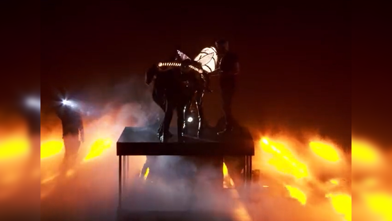 Contestant wearing mask starts choking on stage during performance ...