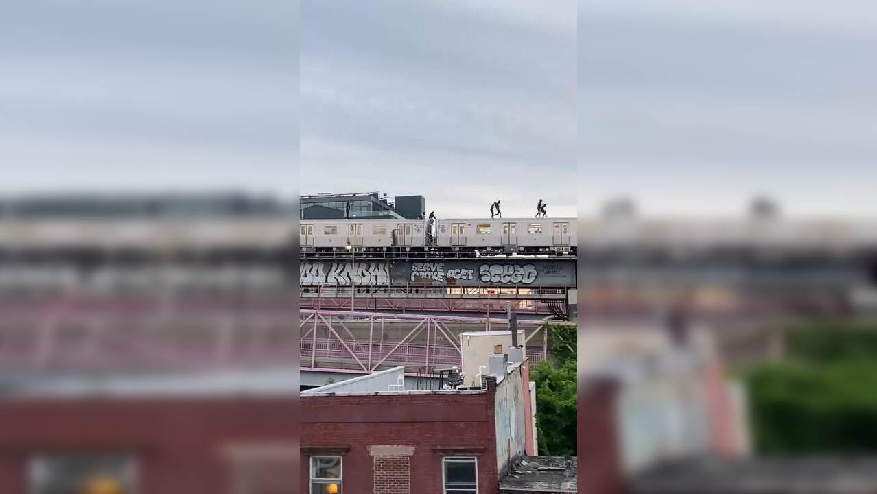 A group of fearless subway surfers was filmed moving on top of a moving ...