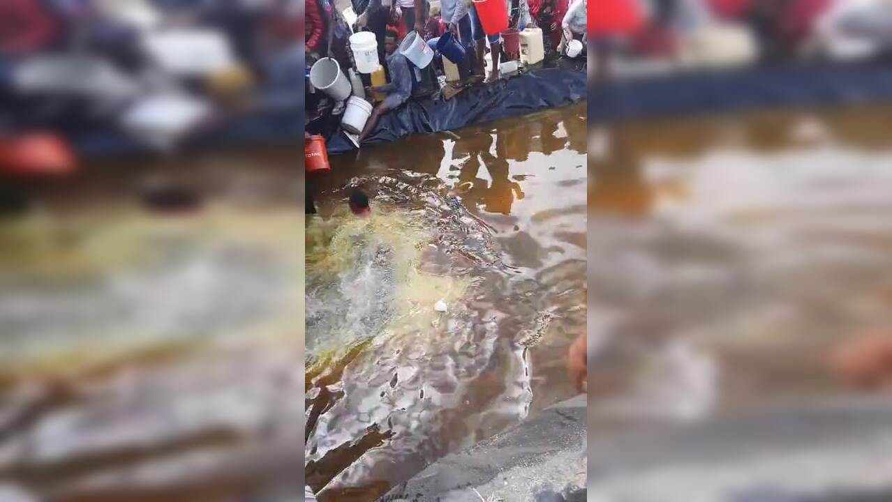 People filmed swimming in 'pool of fuel' after tanker accident ...