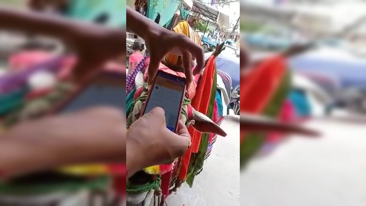 Street performer accepts digital payments through QR code placed on his ...