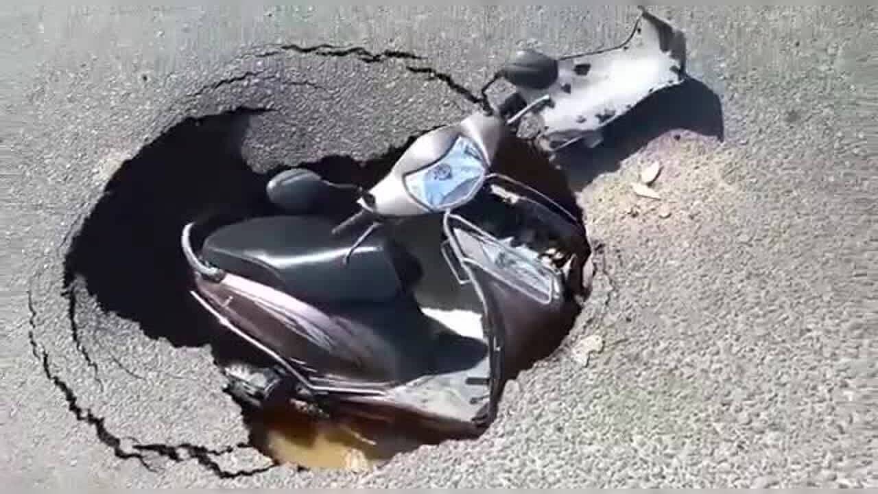 Viral video: Jodhpur man riding scooty falls into sinkhole | Times Now