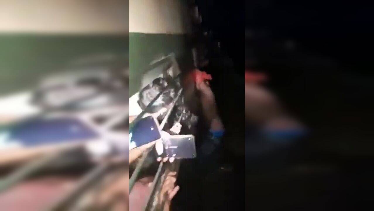 Viral video: Passengers hold shirtless phone thief dangling from train ...