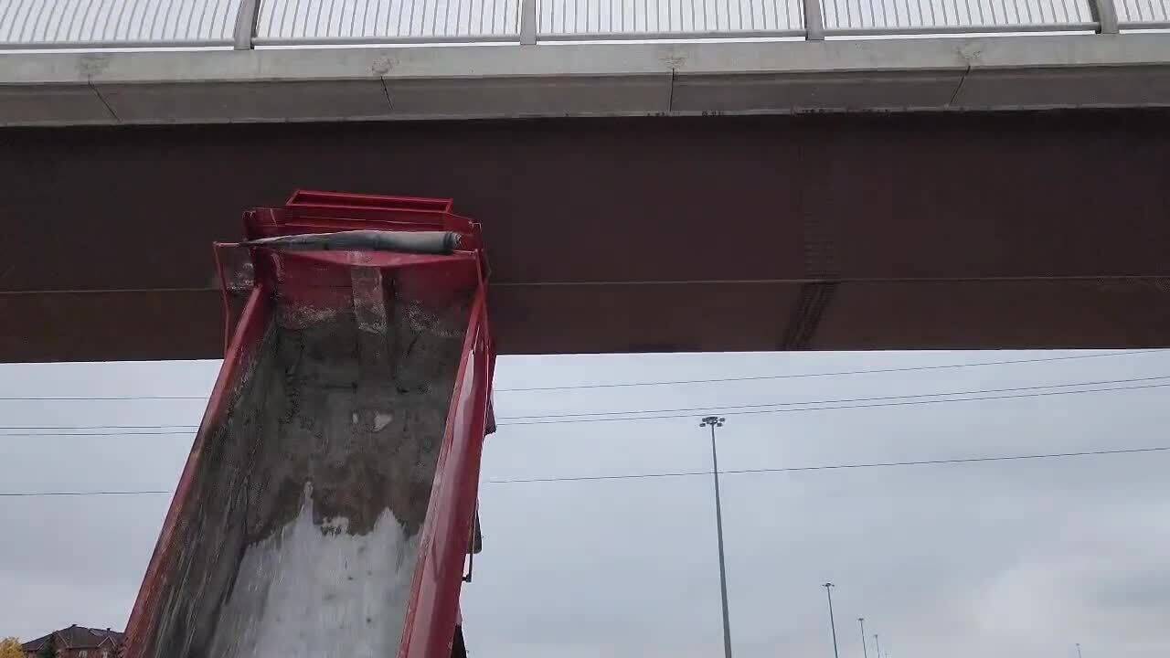 'How did it get there': Garbage truck box gets wedged between highway ...