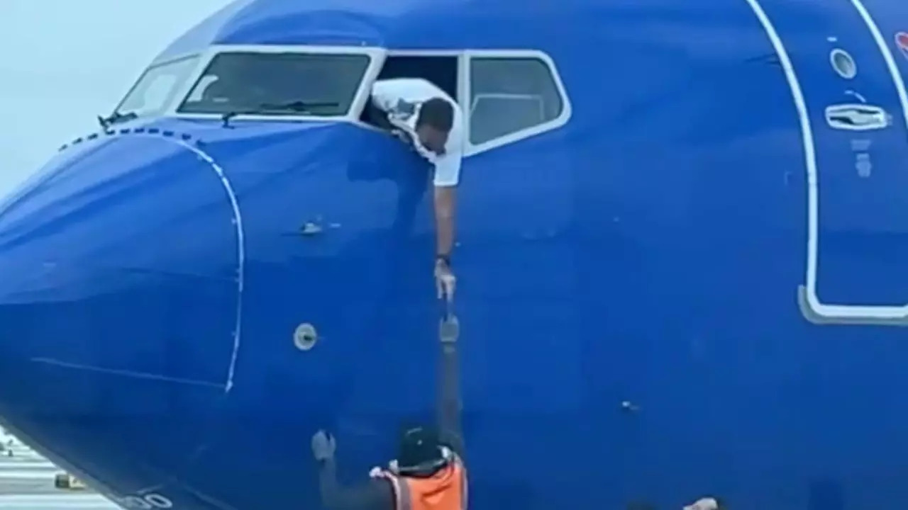 Viral Video Pilot Hangs Out Of Cockpit Window To Get Passengers Lost Phone Times Now