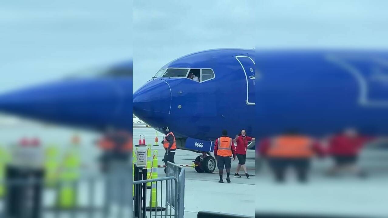 Viral Video: Pilot hangs out of plane window to take phone passenger ...