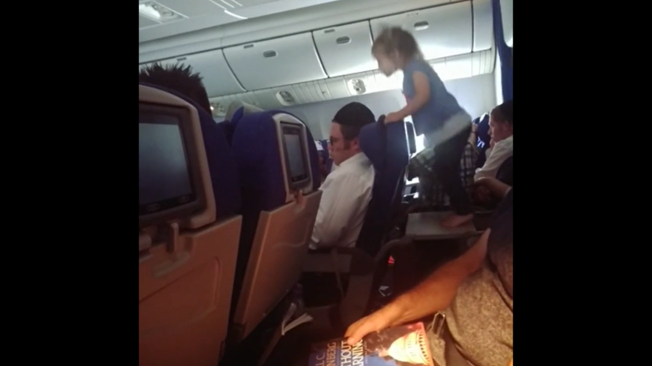 'Wild' child jumps barefoot on plane's tray table during 8-hour flight ...