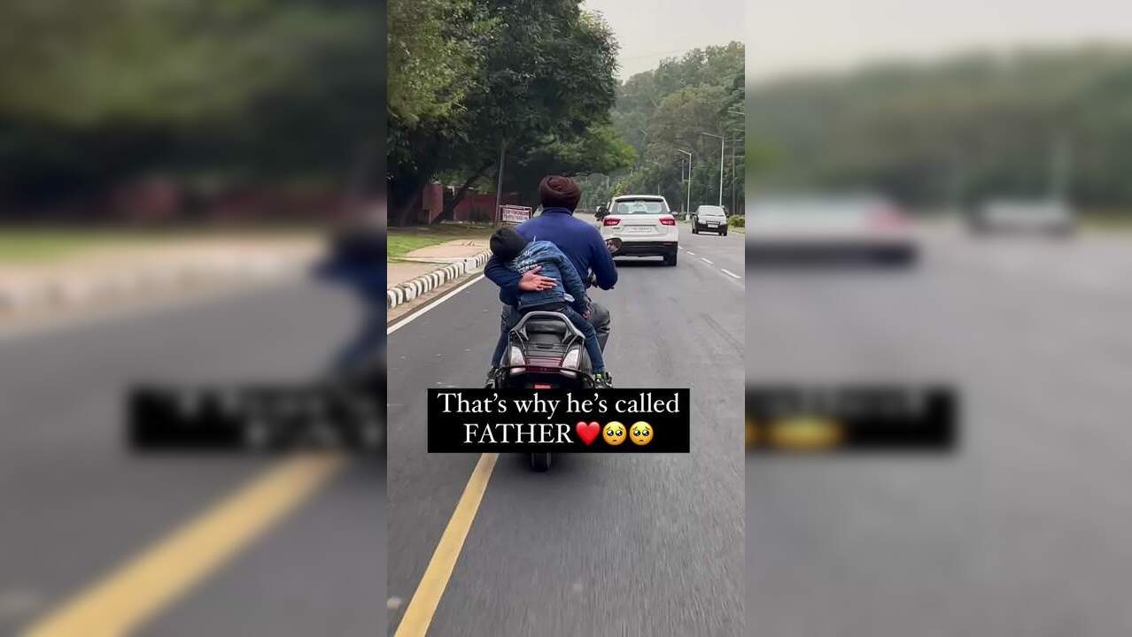 Heartwarming video of man riding scooter with sleeping son goes viral ...