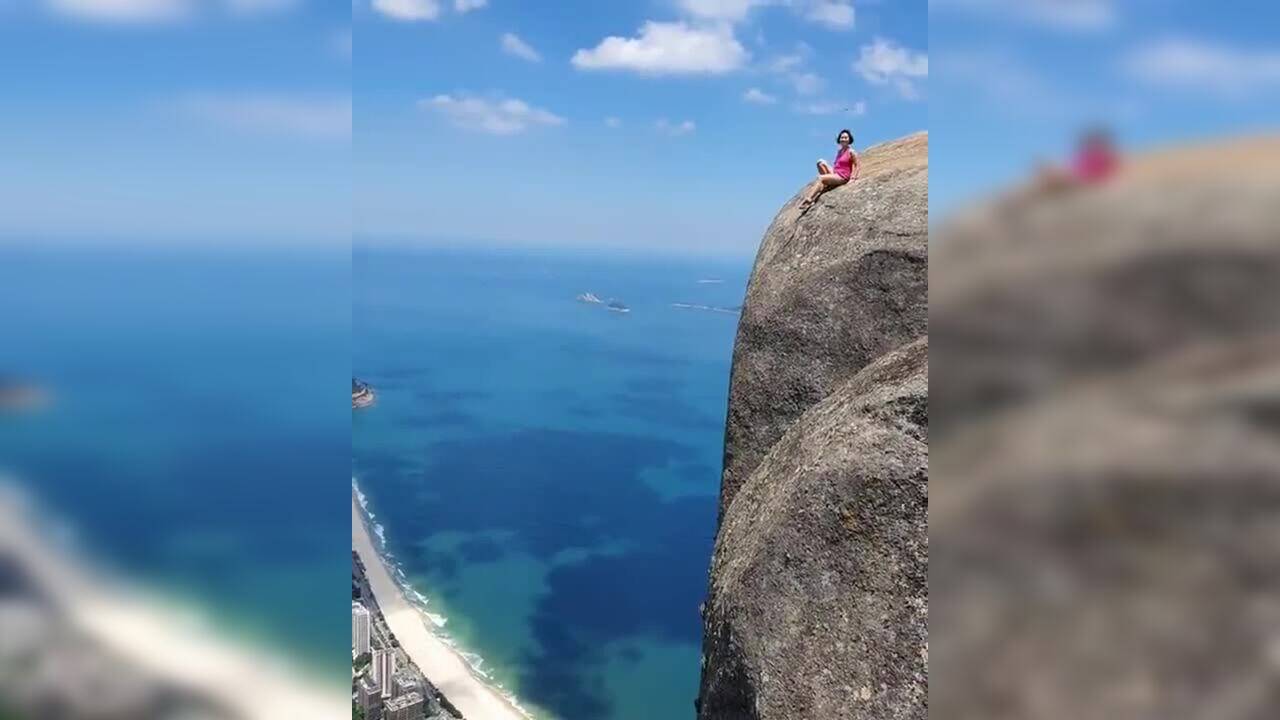 Woman poses on edge of nearly 2,800-feet-high cliff in Brazil's Rio ...